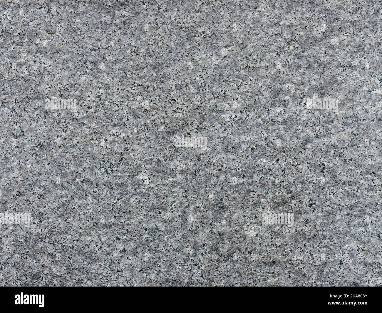 Background from gray granite with potholes and splashes of light stones ...