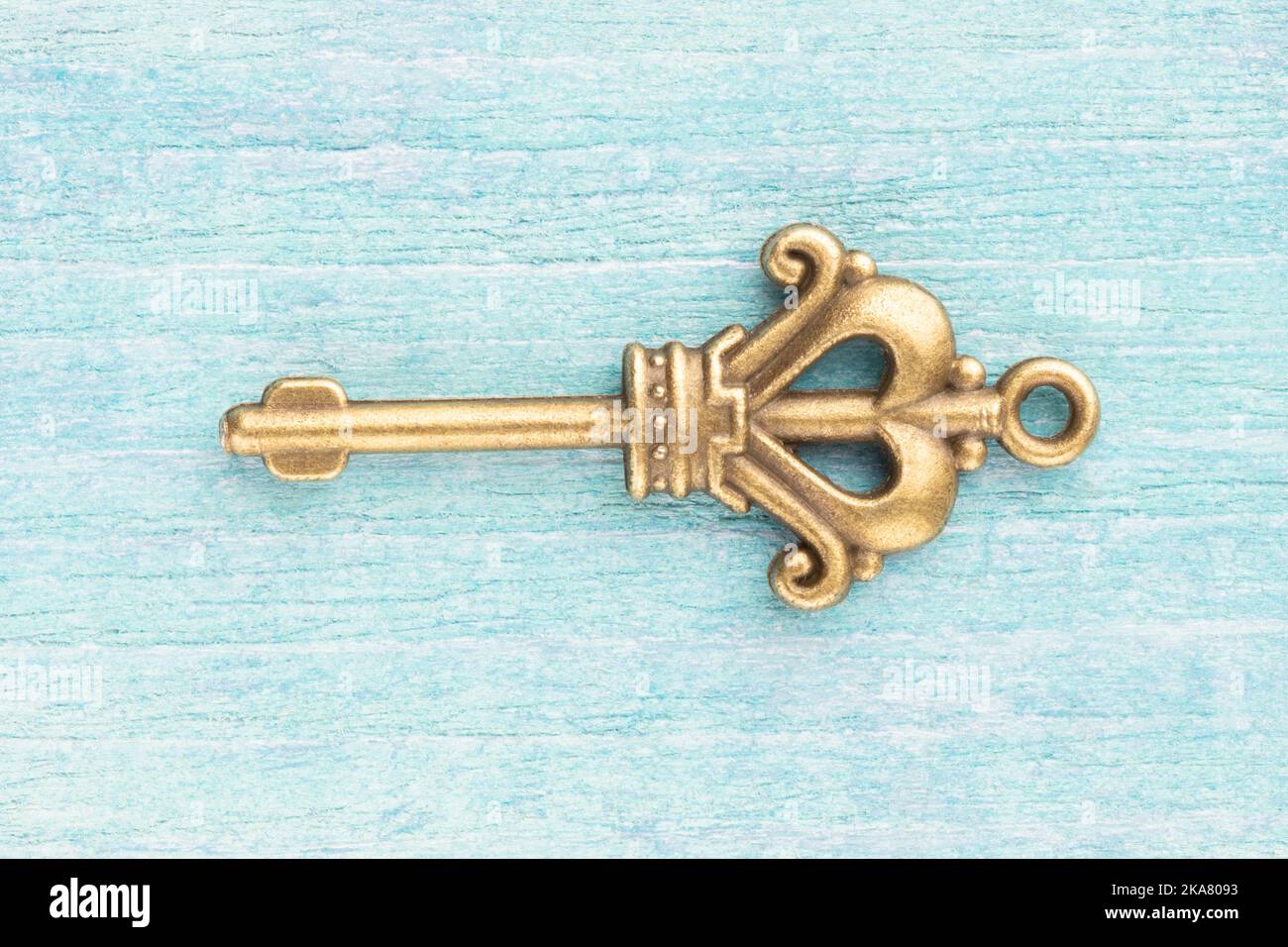 Bronze vintage antique key on blue wooden background. Old keys concept ...