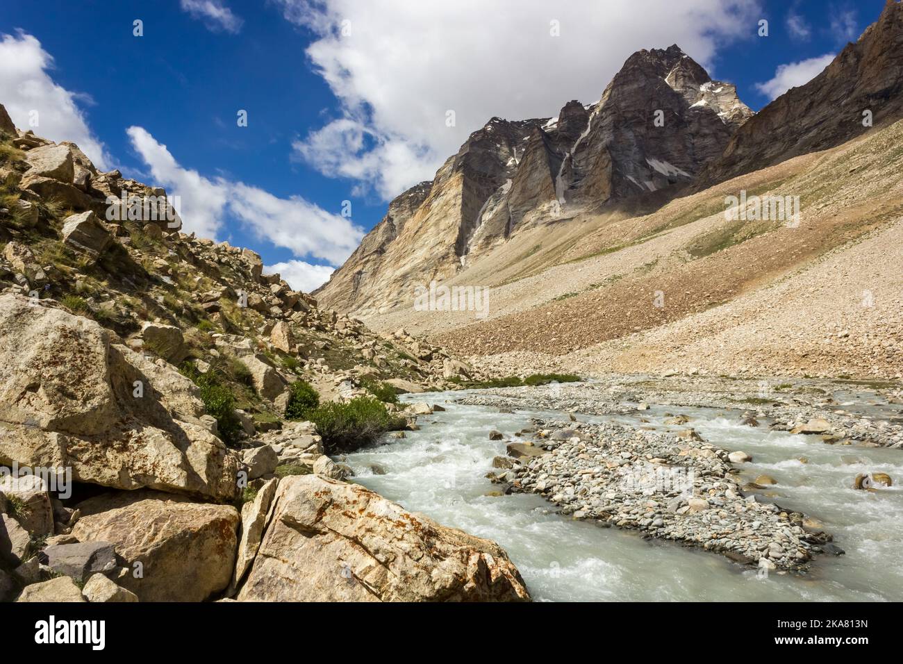The Zanskar river flows through the high rocky mountains on a trekking ...