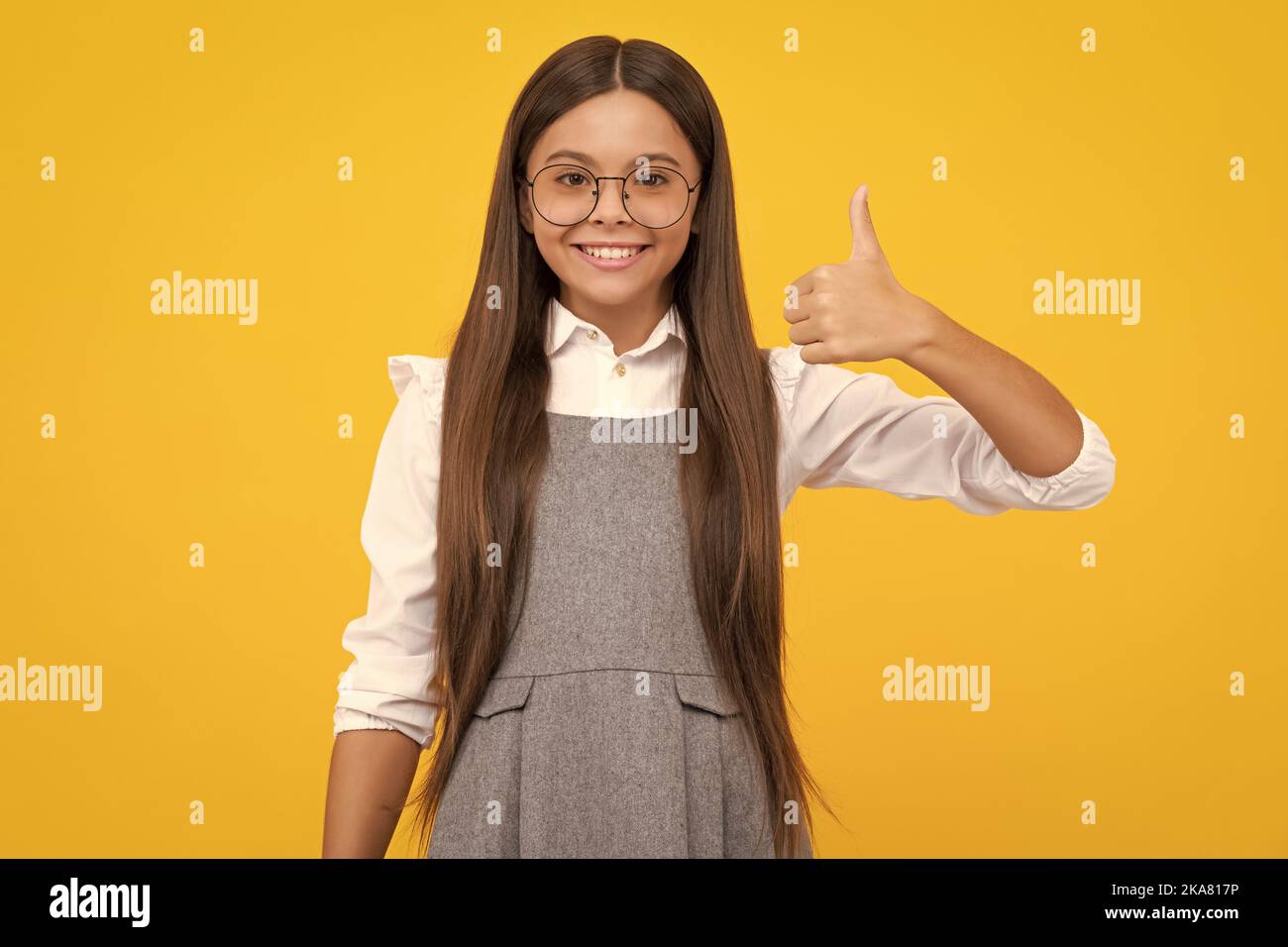 Happy funny teenager child girl show sight thumbs up and good luck ...