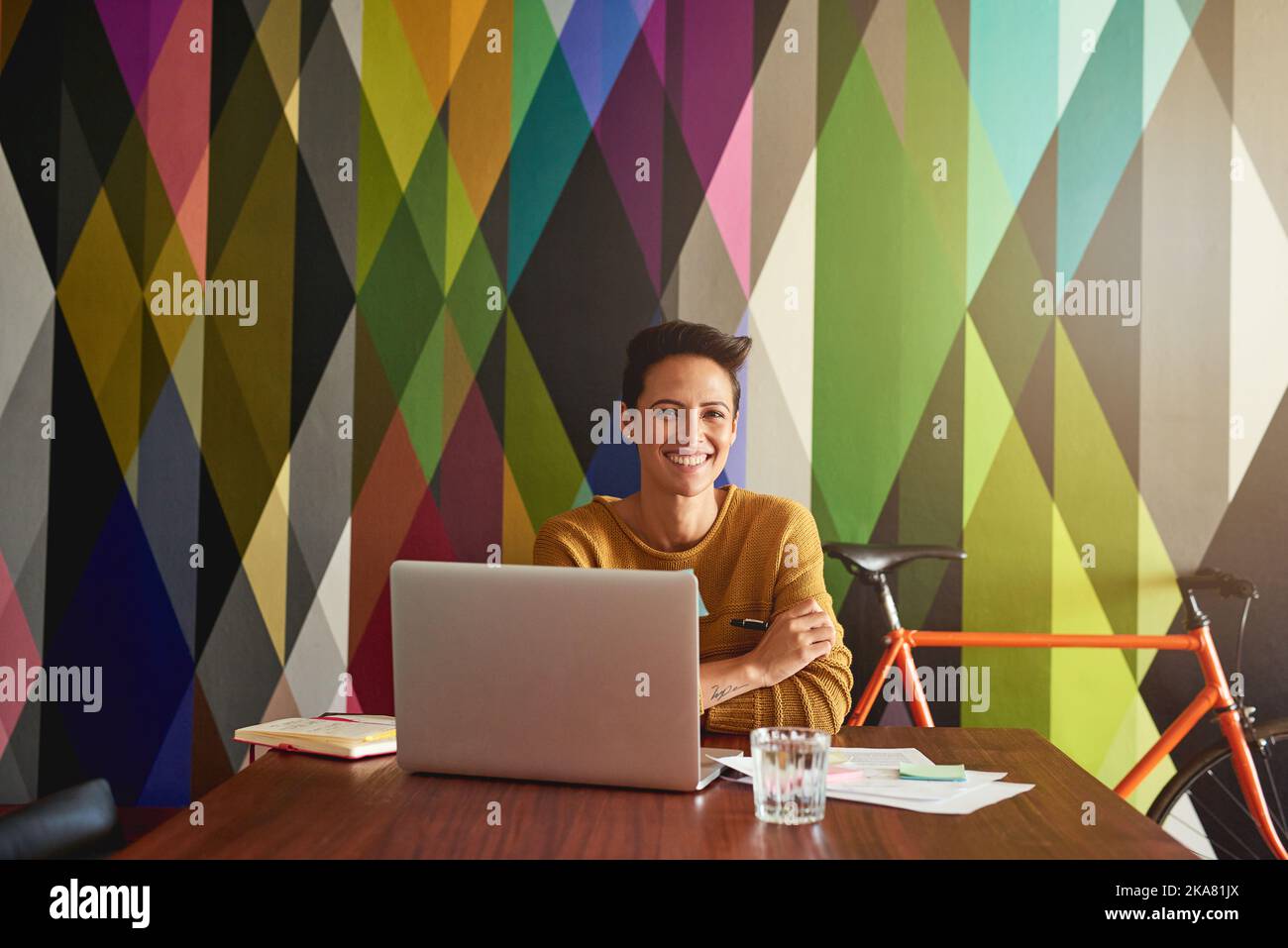 Working on her designs. a creative employee working in a modern office ...