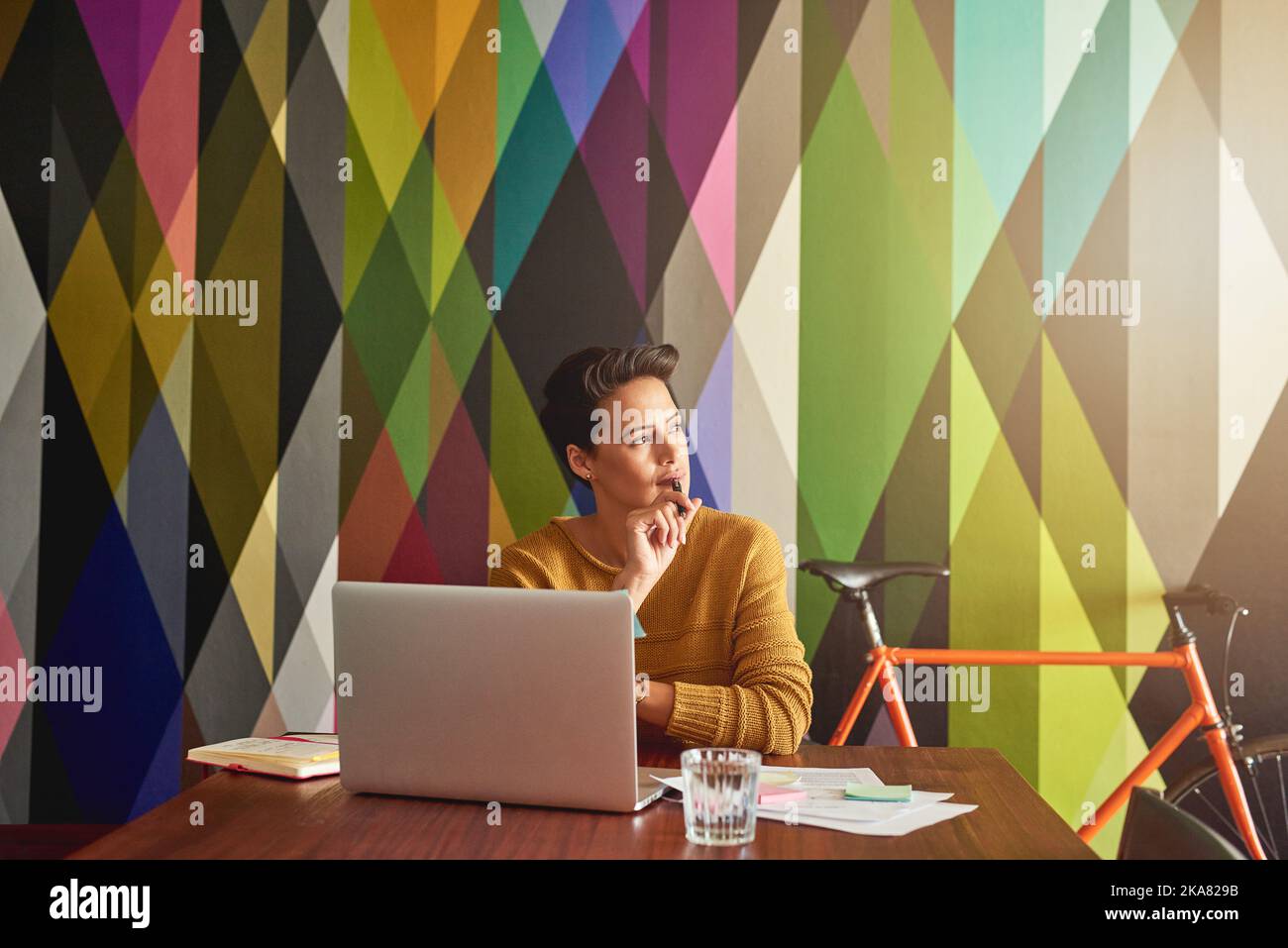 Thinking about innovative ideas. a creative employee working in a ...