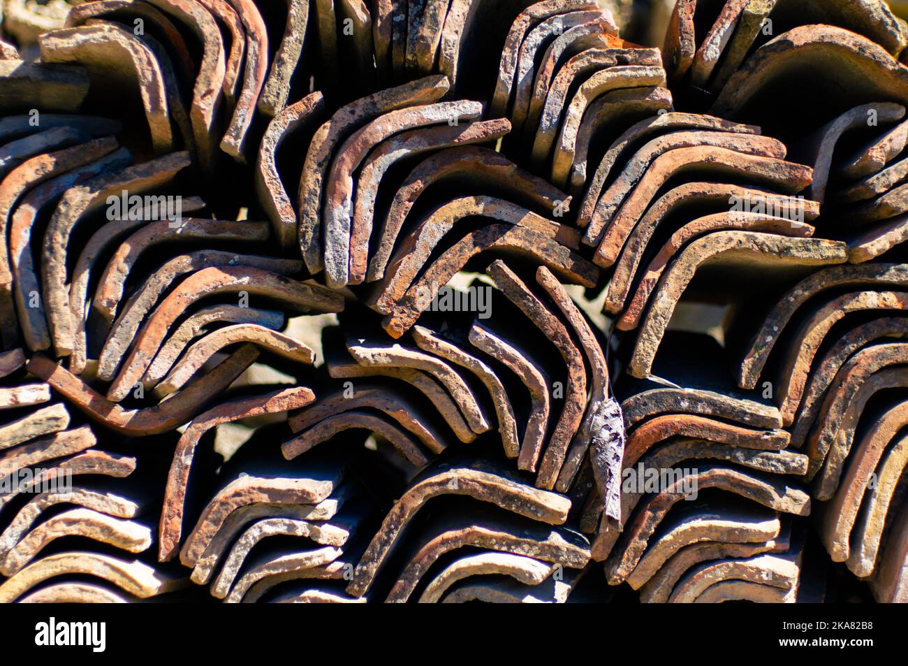 A stack of tiles, a clay roof, background and texture. Front view Stock ...