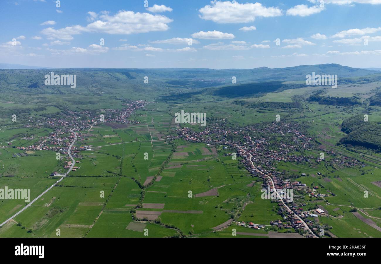 An aerial view of a landscape with fields and villages in Transylvania ...