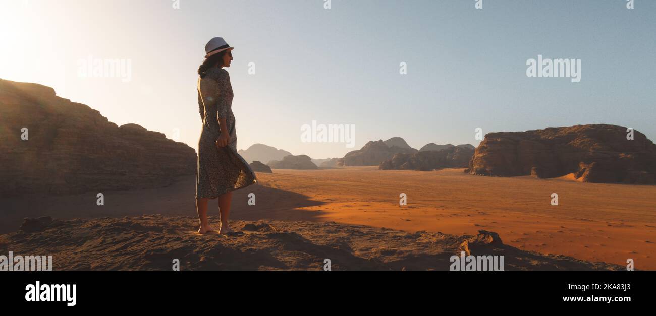 Woman tourist stand on cliff at viewpoint enjoy Wadi rum panorama on ...