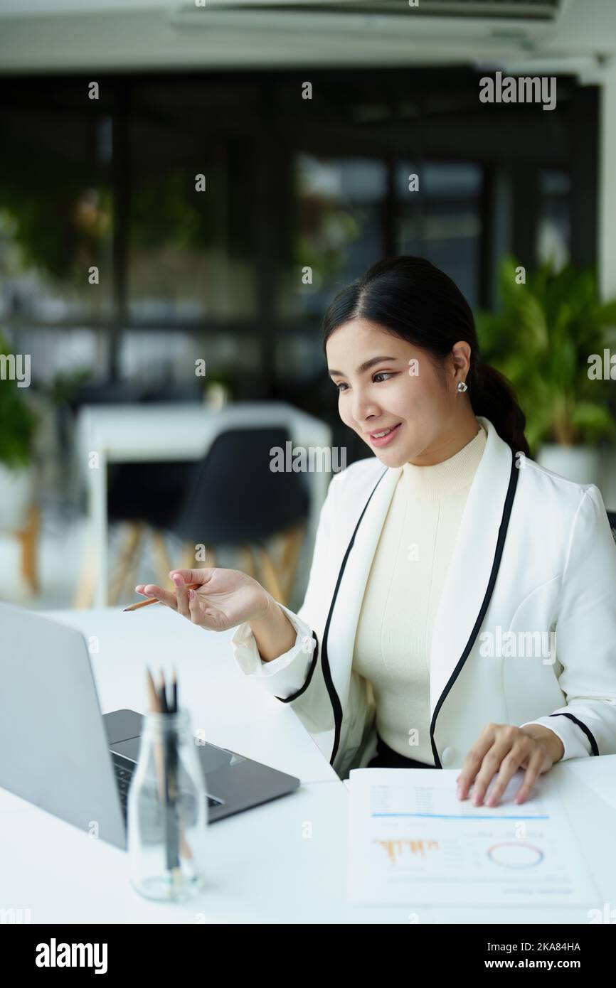 Portrait of a female employee using a computer for video conferencing ...