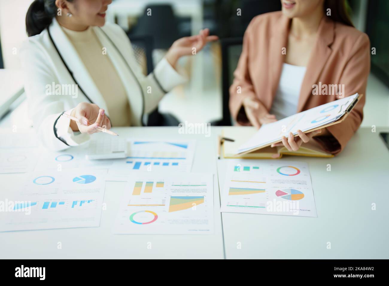 marketing employee and a salesperson using product documentation to ...