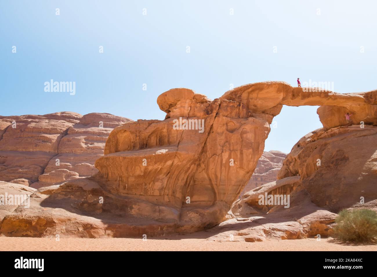 Bottom view caucasian woman tourist stand on famous arch bridge in wadi ...
