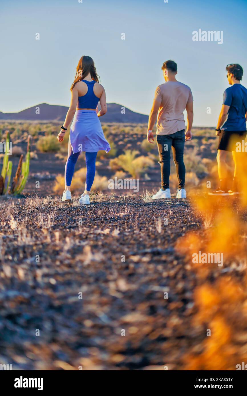 A vertical shot of people standing in a desert under the sunlight Stock ...