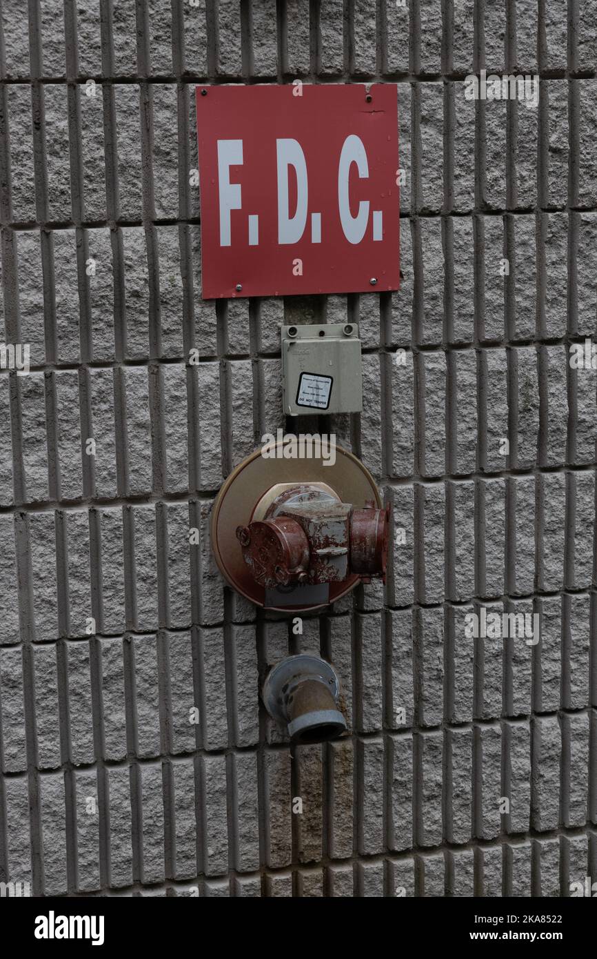 A vertical closeup of the exterior of fire department connections ...