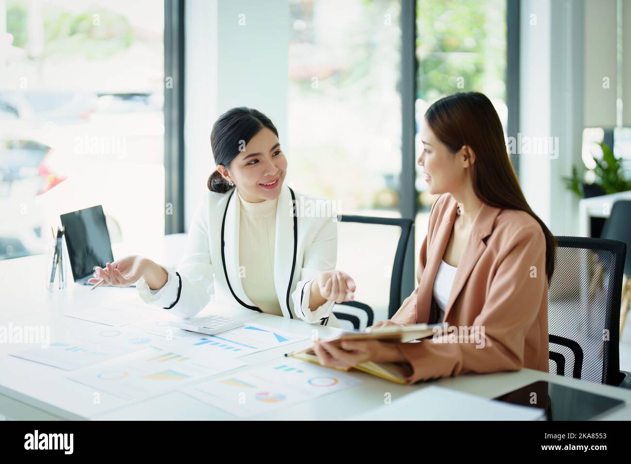 marketing employee and a salesperson using product documentation to ...