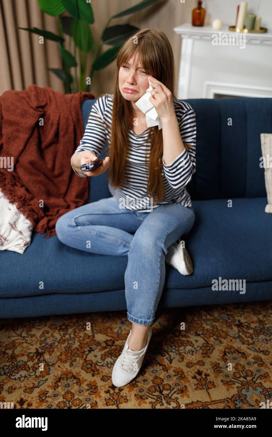 Crying Emotional Woman Sitting On The Sofa And Watching A Romantic