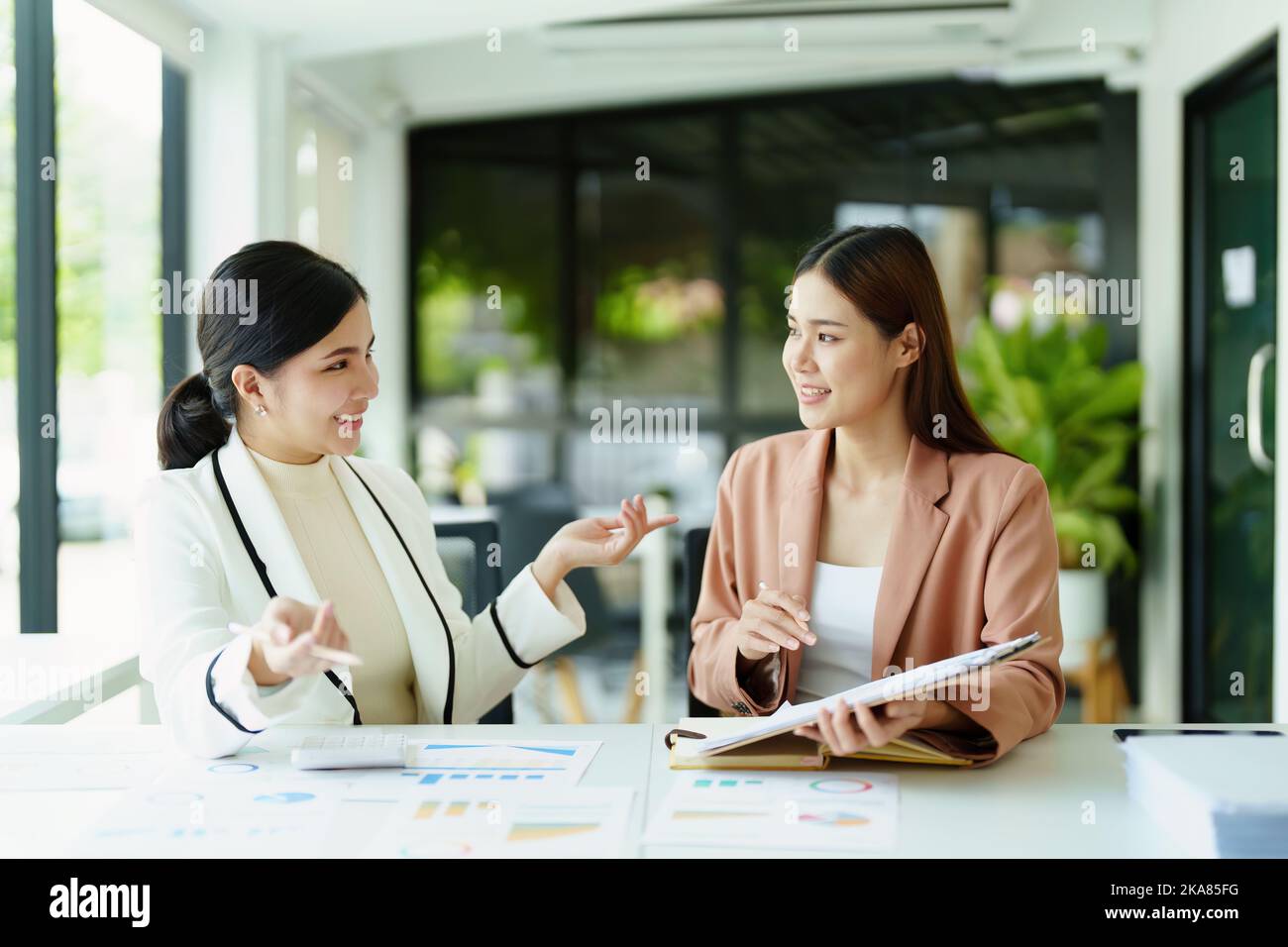 marketing employee and a salesperson using product documentation to ...