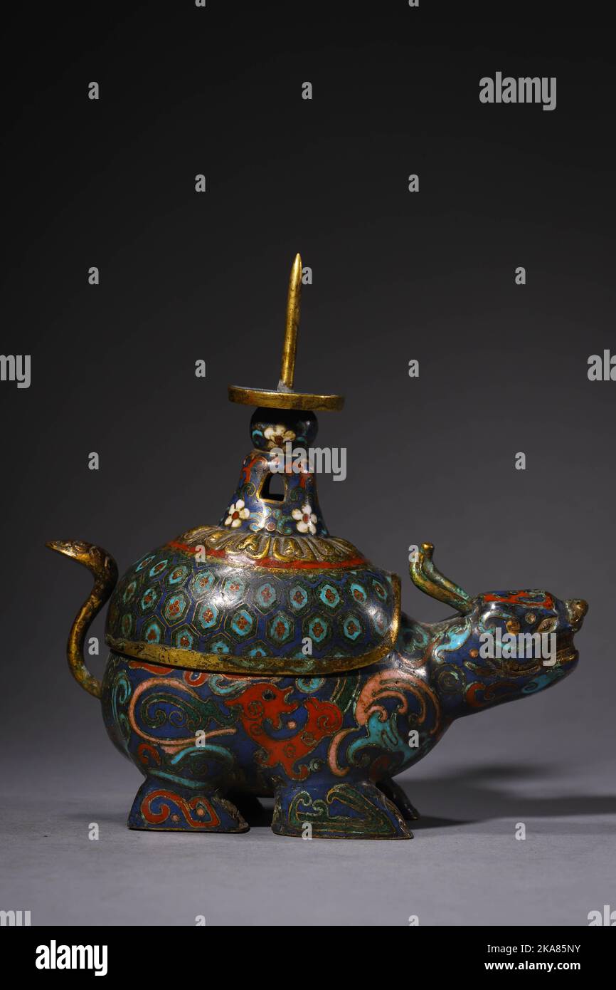 A vertical view of an antique Chinese style Cloisonne gilt bronze ...