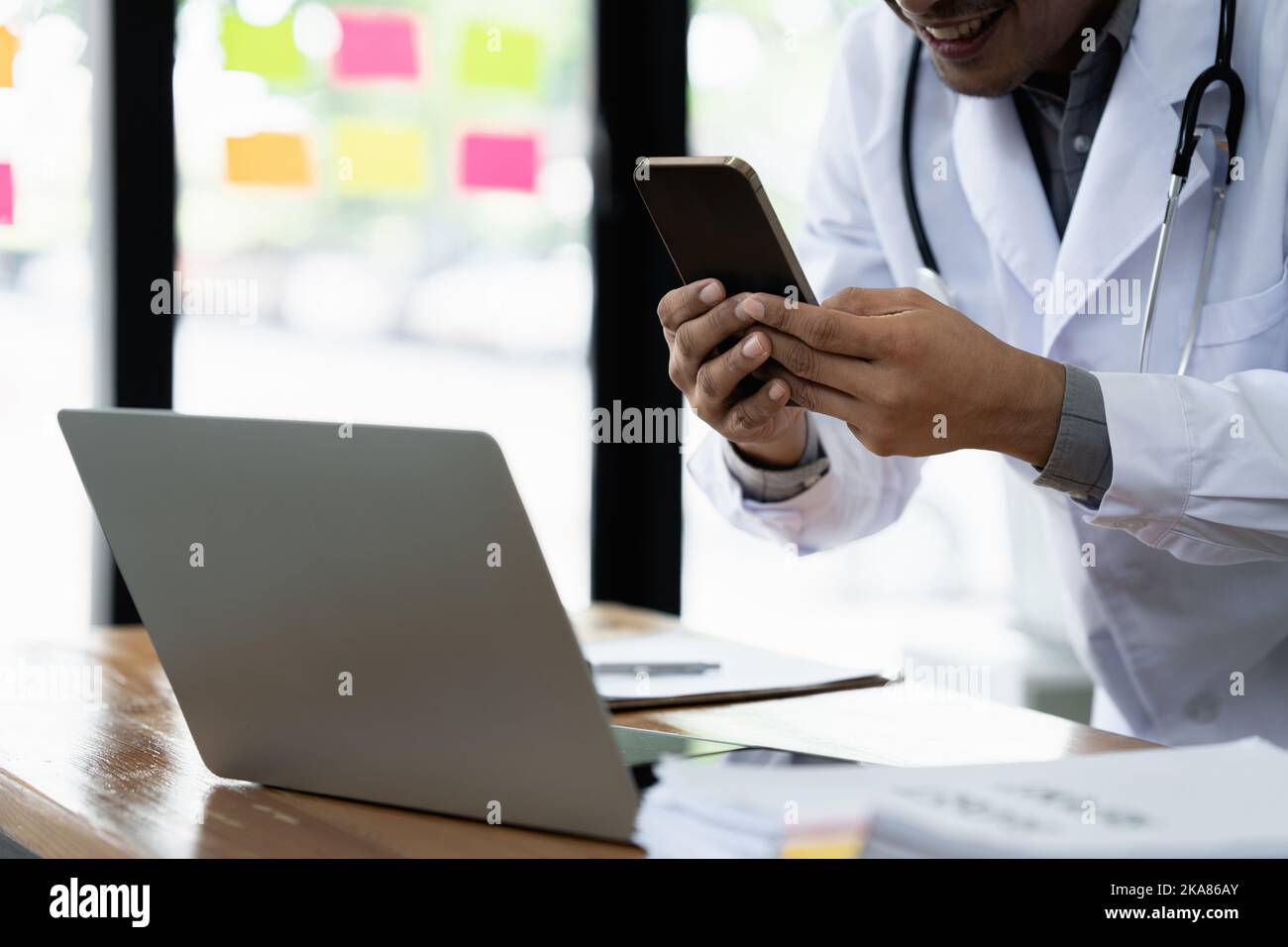 Doctor working using cell phone at clinic. Medical technology and ...