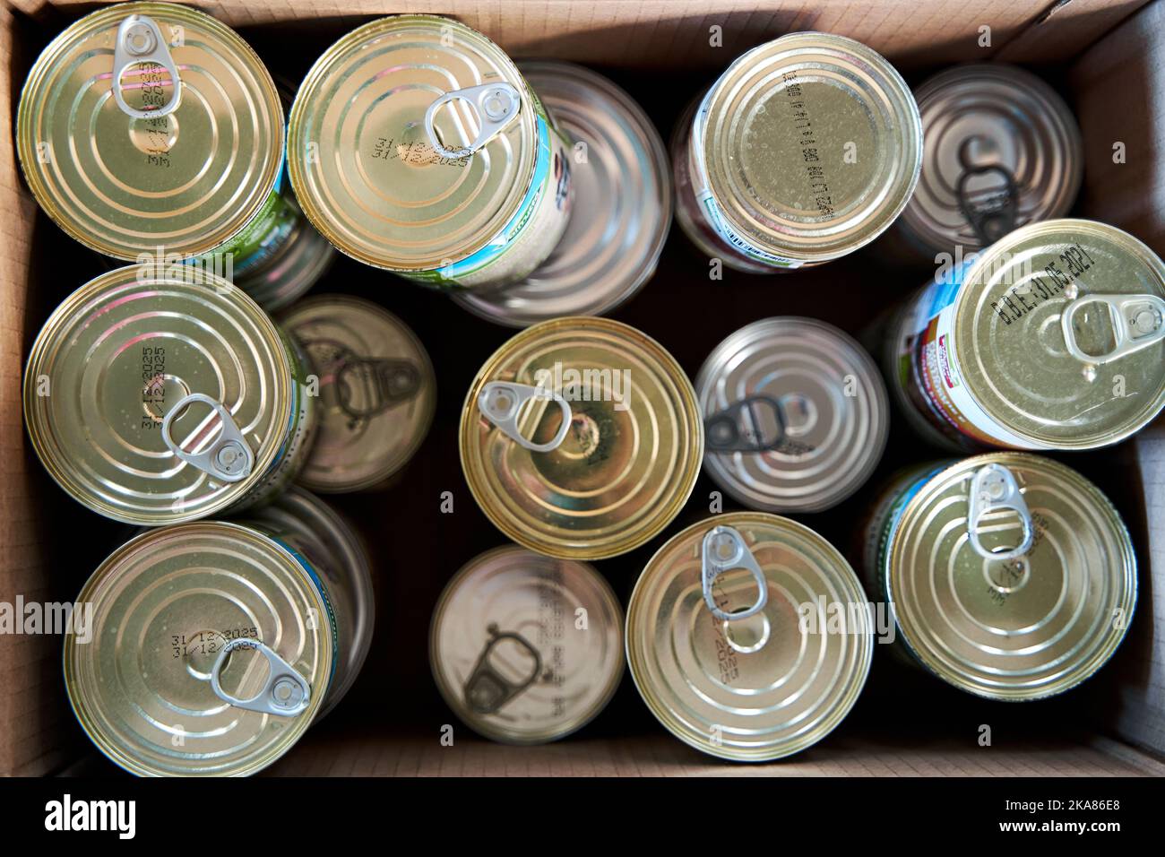 Paper box filled with canned food Stock Photo - Alamy