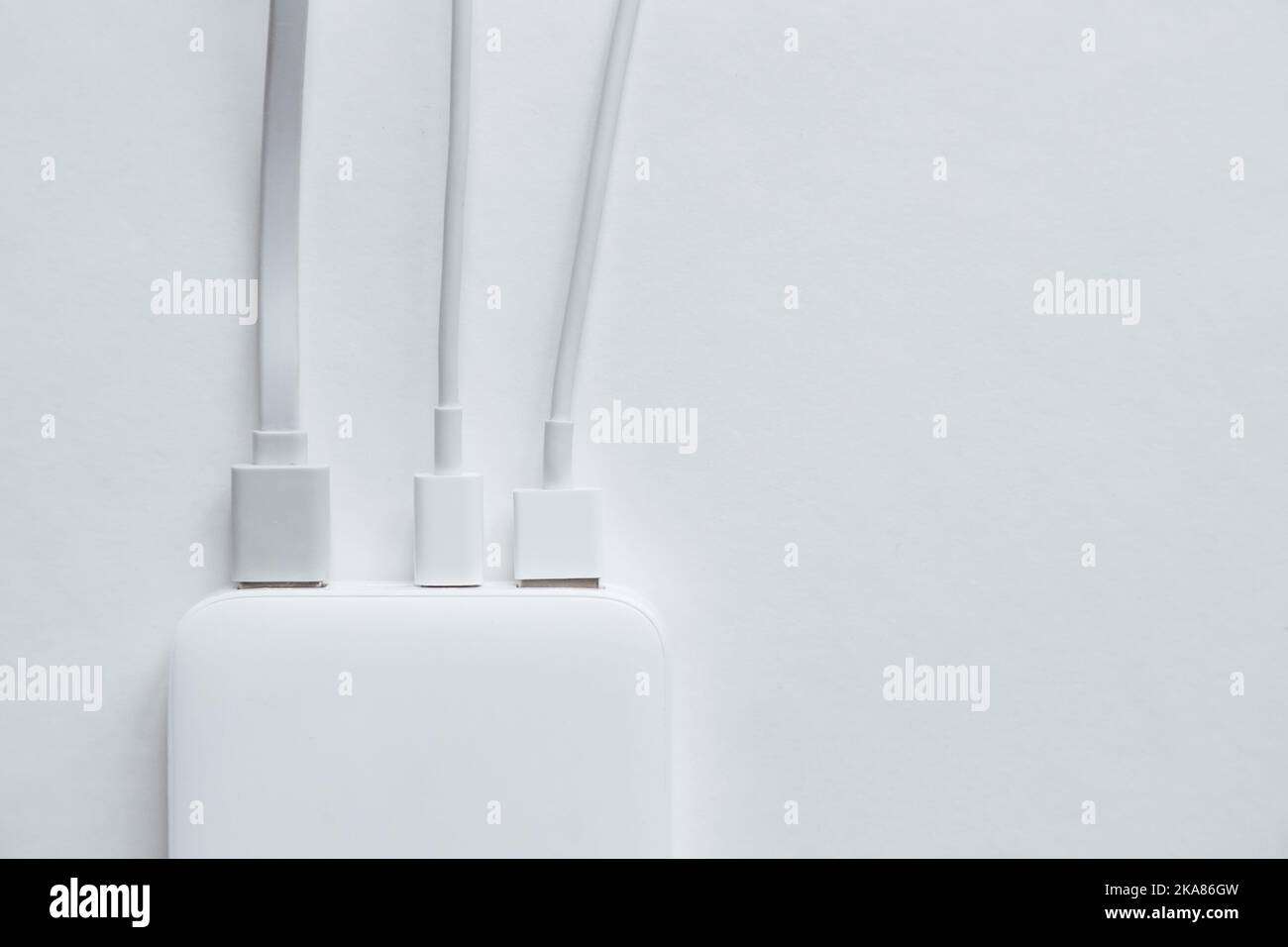 Power bank, portative pocket charger with plugged cables on white ...