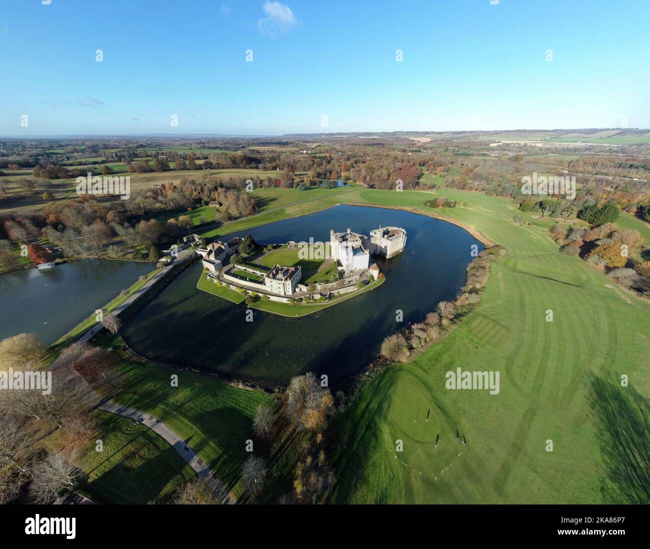 The bird's eye view of the Leeds Castle on the lake surrounded by green ...