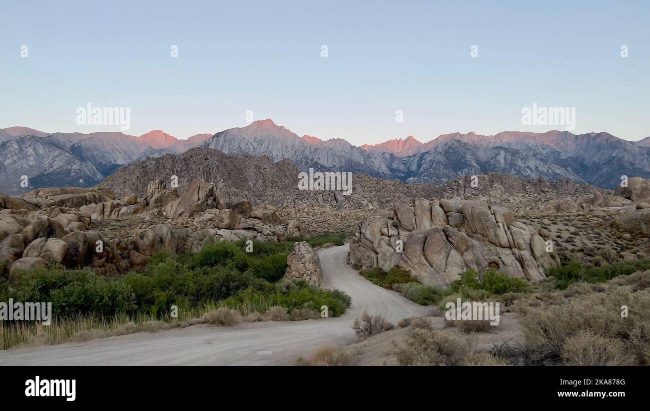 A scenic view of an empty asphalt road surrounded by rocky mountains ...