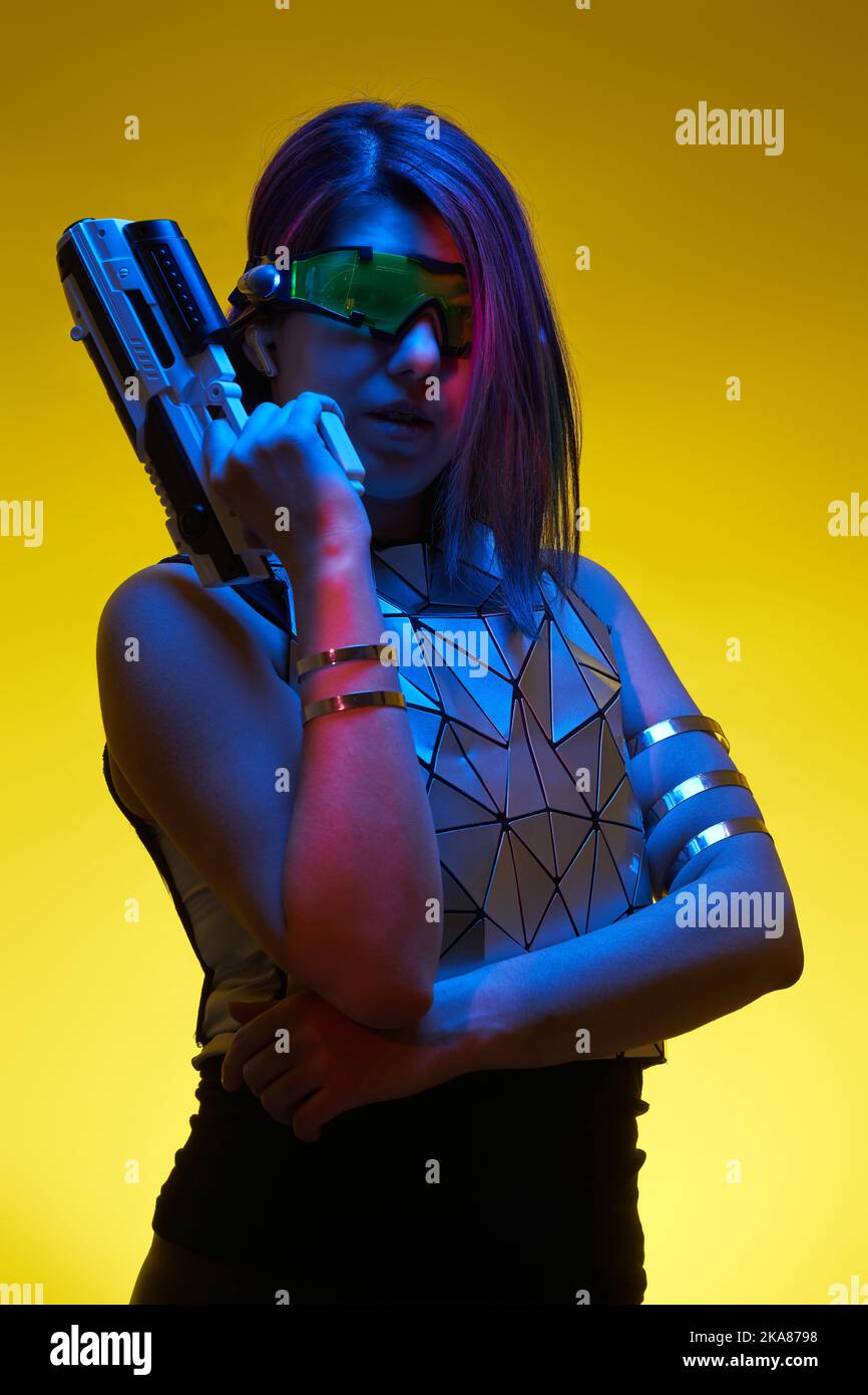 Girl with blaster in the futuristic battle. Concept virtual reality ...