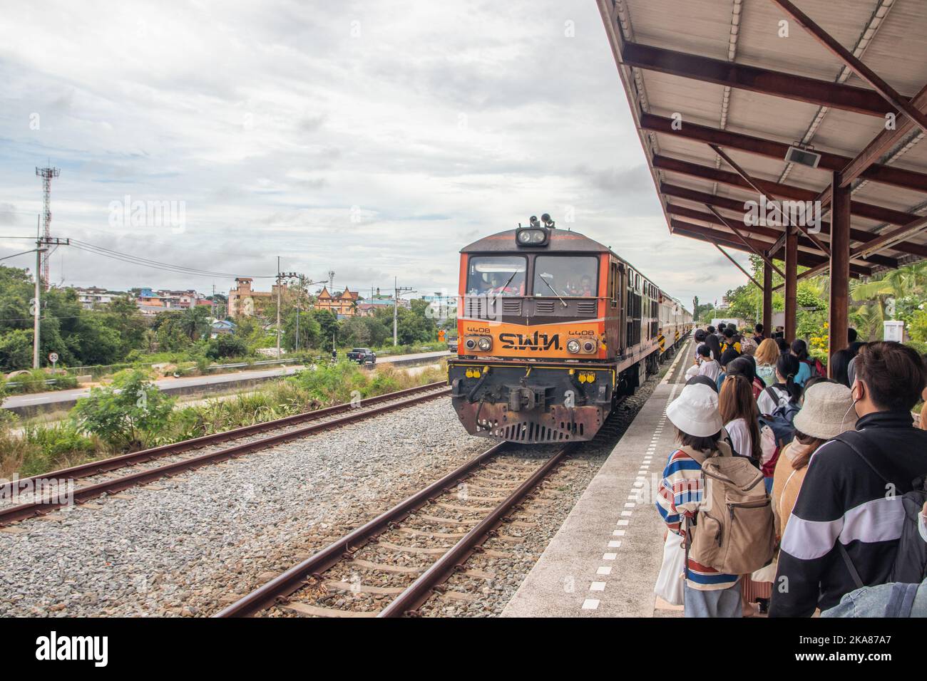 People wait at a platform in Pattaya for the incoming train bound for ...