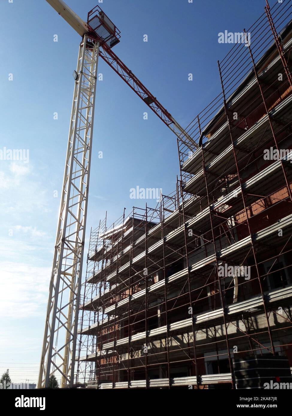 A vertical low angle shot of a construction crane at a construction ...