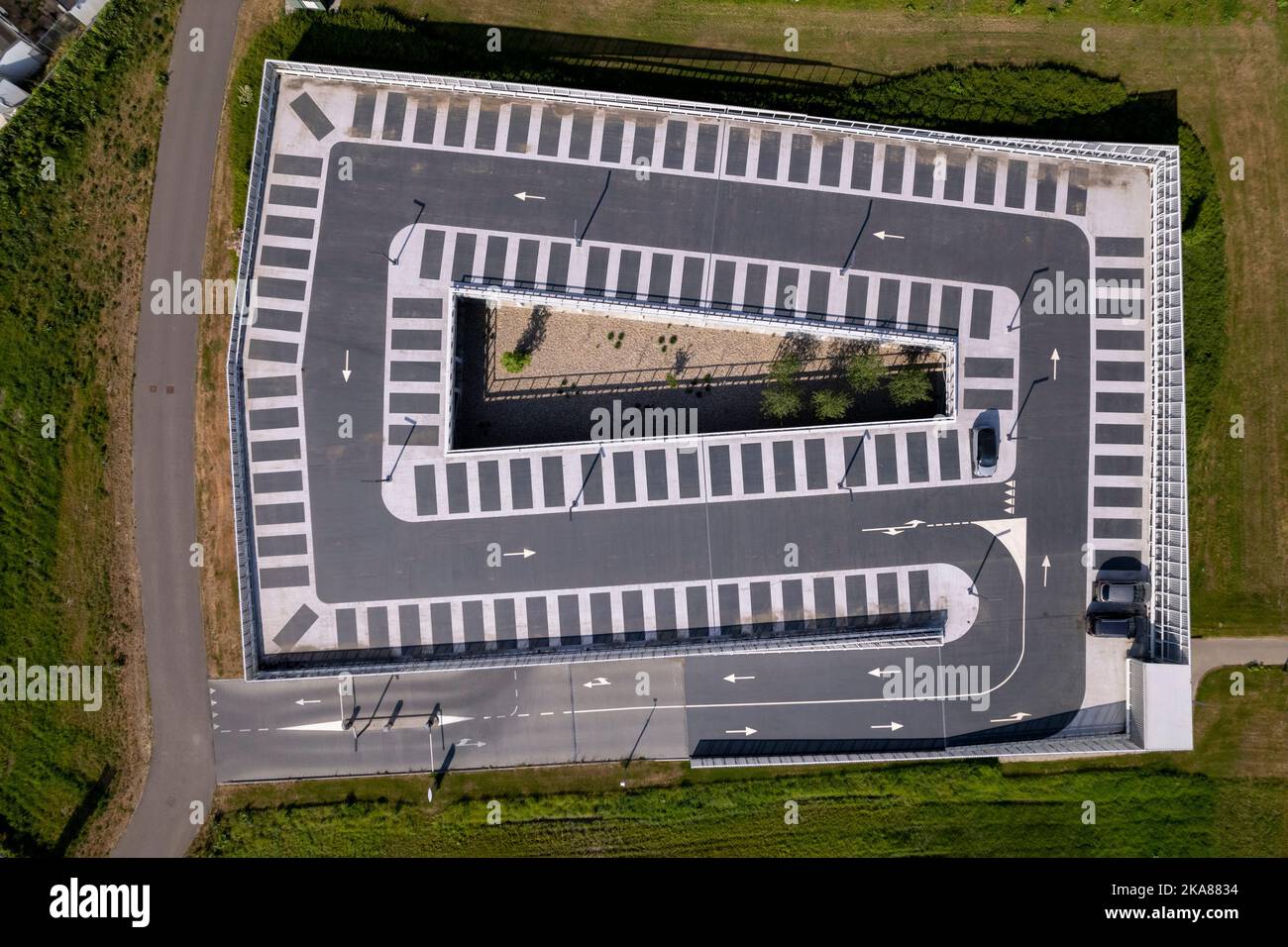 Aerial top down view with a single car parked in graphic outline ...