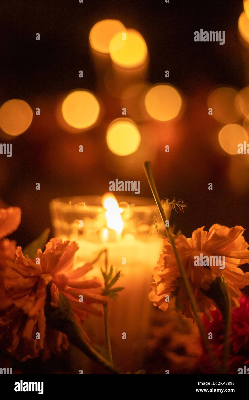 Oaxaca, Mexico. 31st Oct, 2022. A candle burns in a decorated cemetery ...