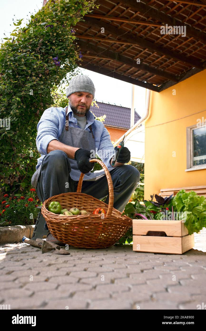 A male farmer sitting in the yard outdoors, resting Stock Photo - Alamy