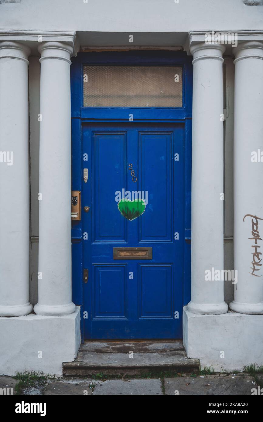 A vertical view of an old blue wooden door at Notting Hill, London ...