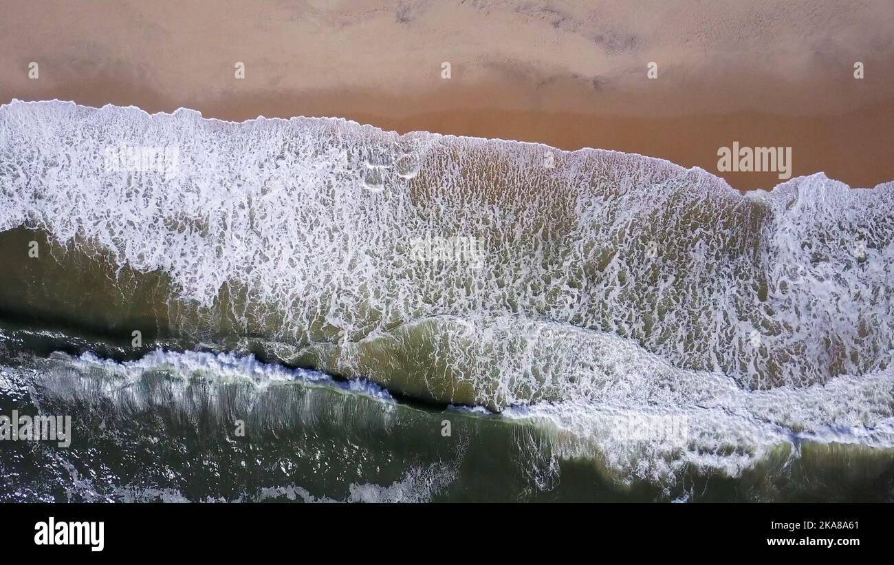 Aerial view of ocean waves crashing on beach, 4K drone footage Stock ...