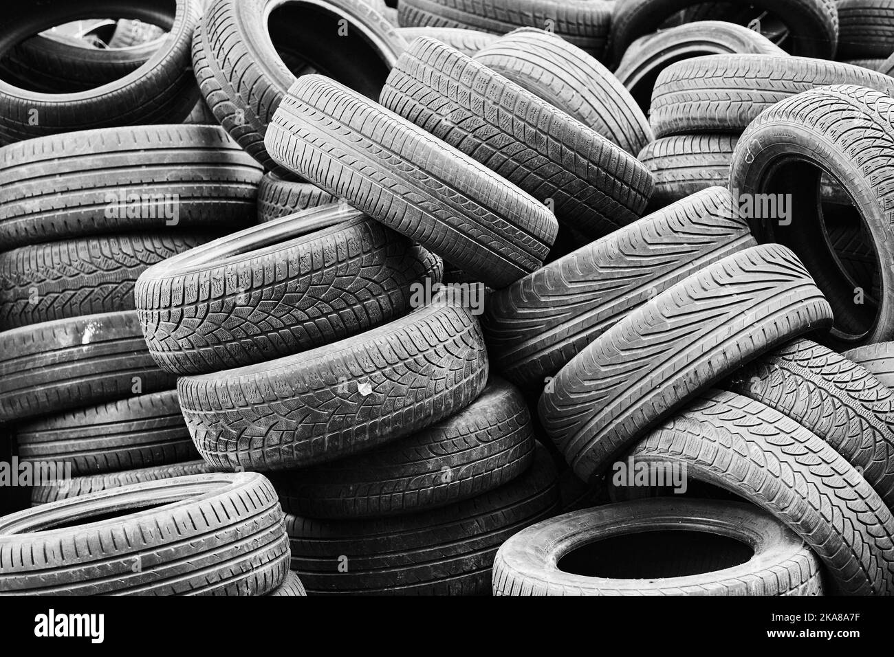 A closeup grayscale shot of many used old car tires- perfect for ...