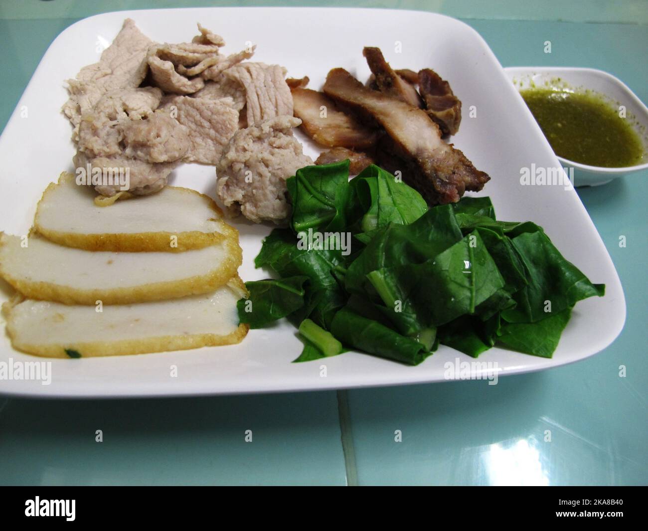 Blanched meat pork and boiled fish balls with dip spicy soy bean sauce ...