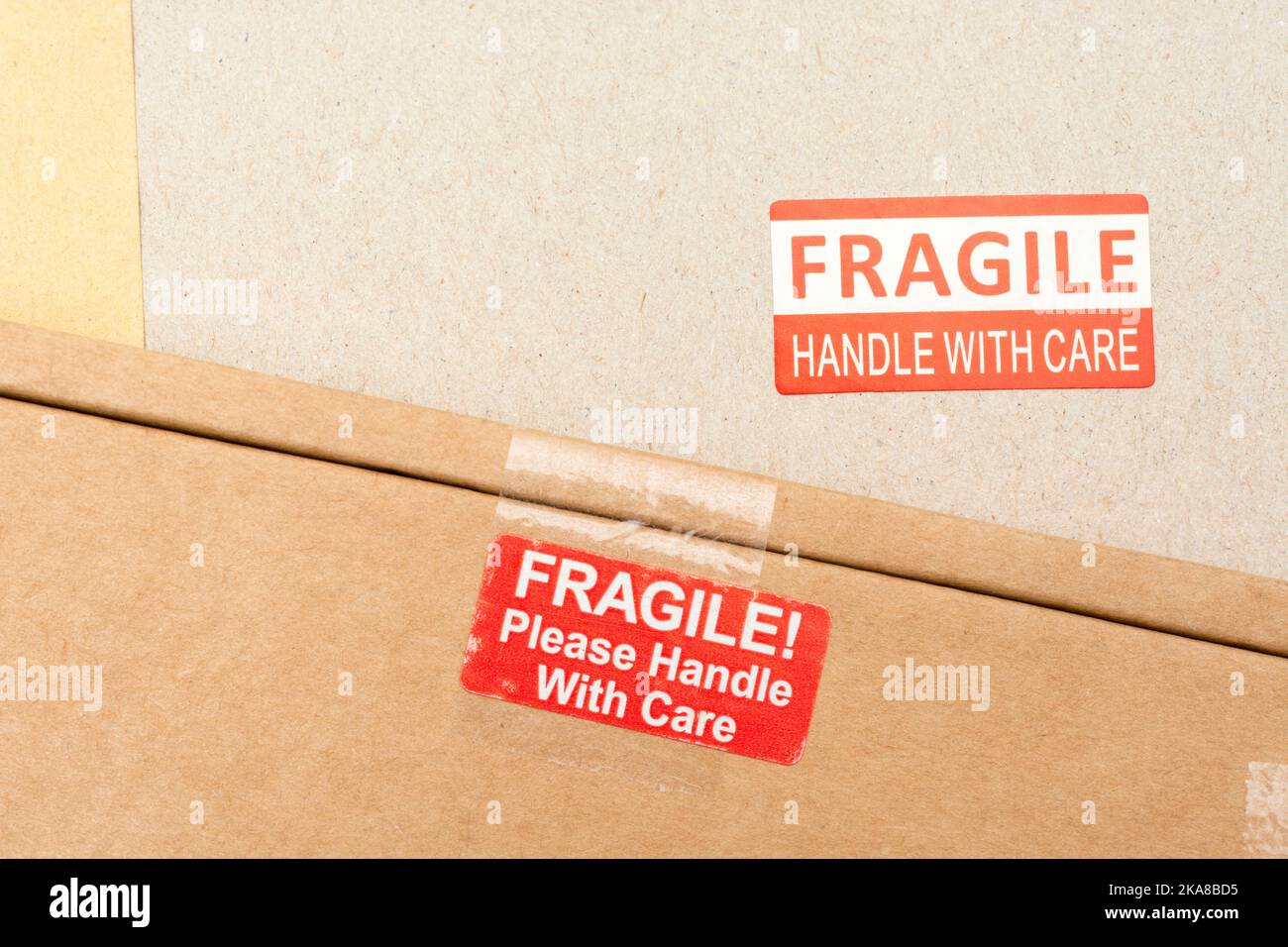 Brown cardboard shipping boxes with red and white adhesive paper label ...