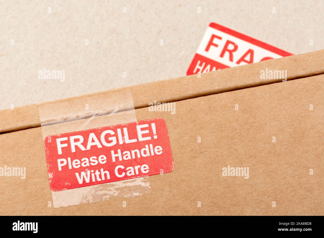 Brown cardboard shipping boxes with red and white adhesive paper label ...