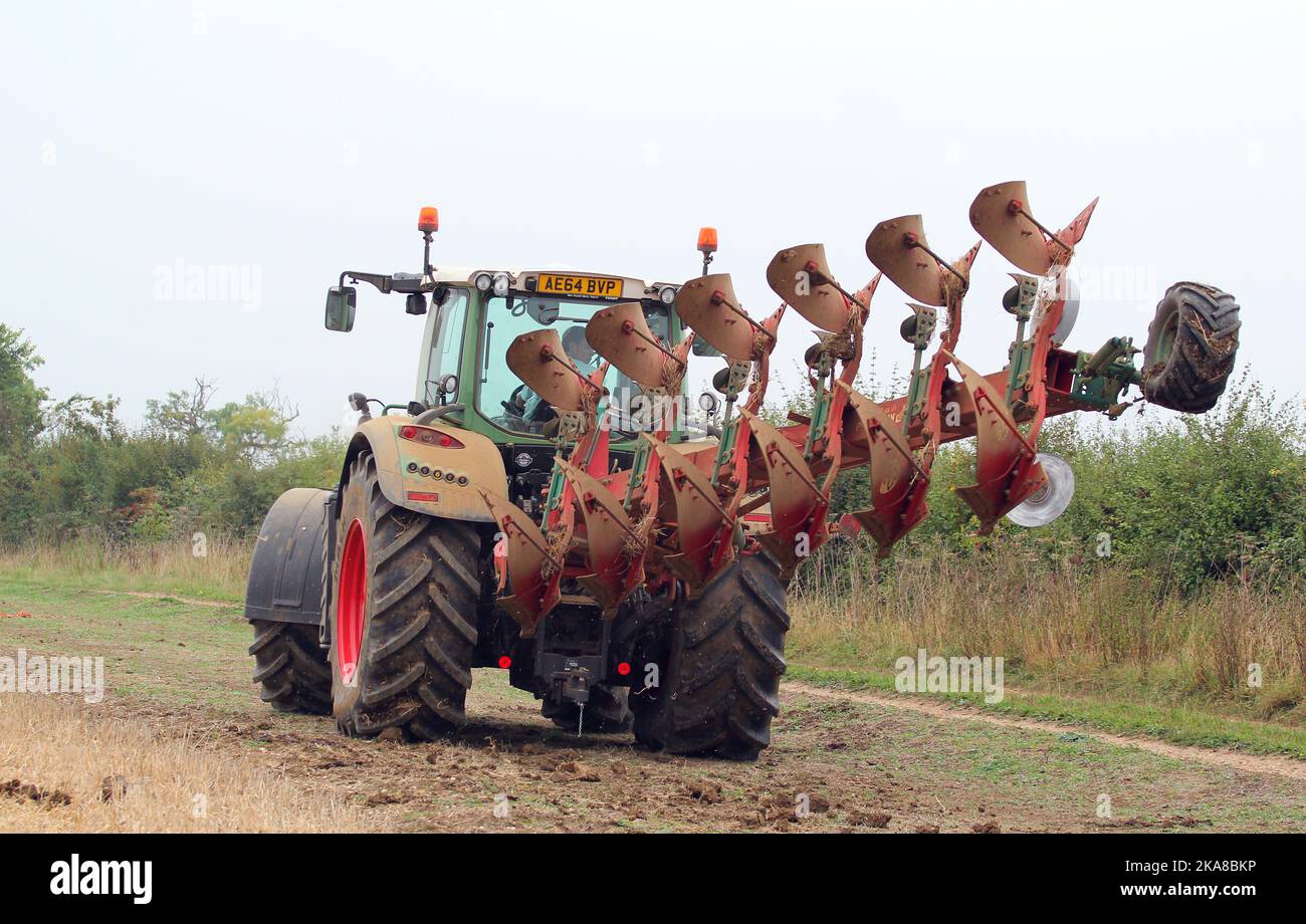Tractor and plough attached. Various shots of tractor ploughing a field ...