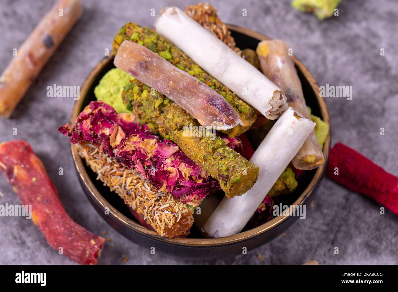 Mixed Turkish delight varieties on a dark background. Pistachio ...