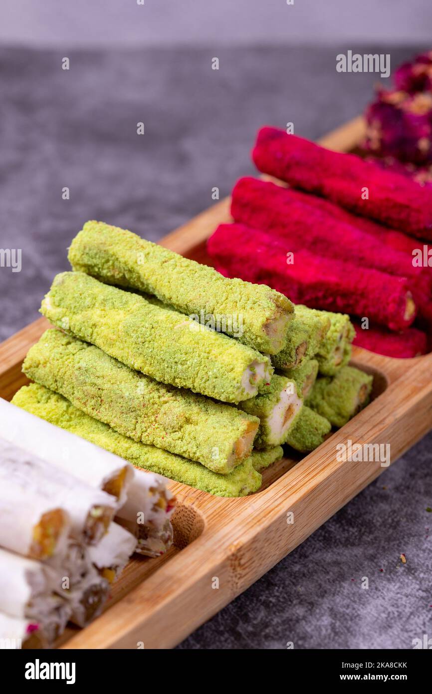 Mixed Turkish delight varieties on a dark background. Pistachio ...