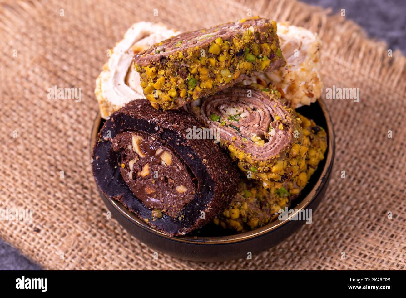 Mixed Turkish delight varieties on a dark background. Pistachio ...