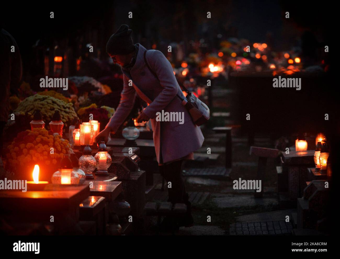 People are seen visiting graves to prepare for All Saints Day at a ...