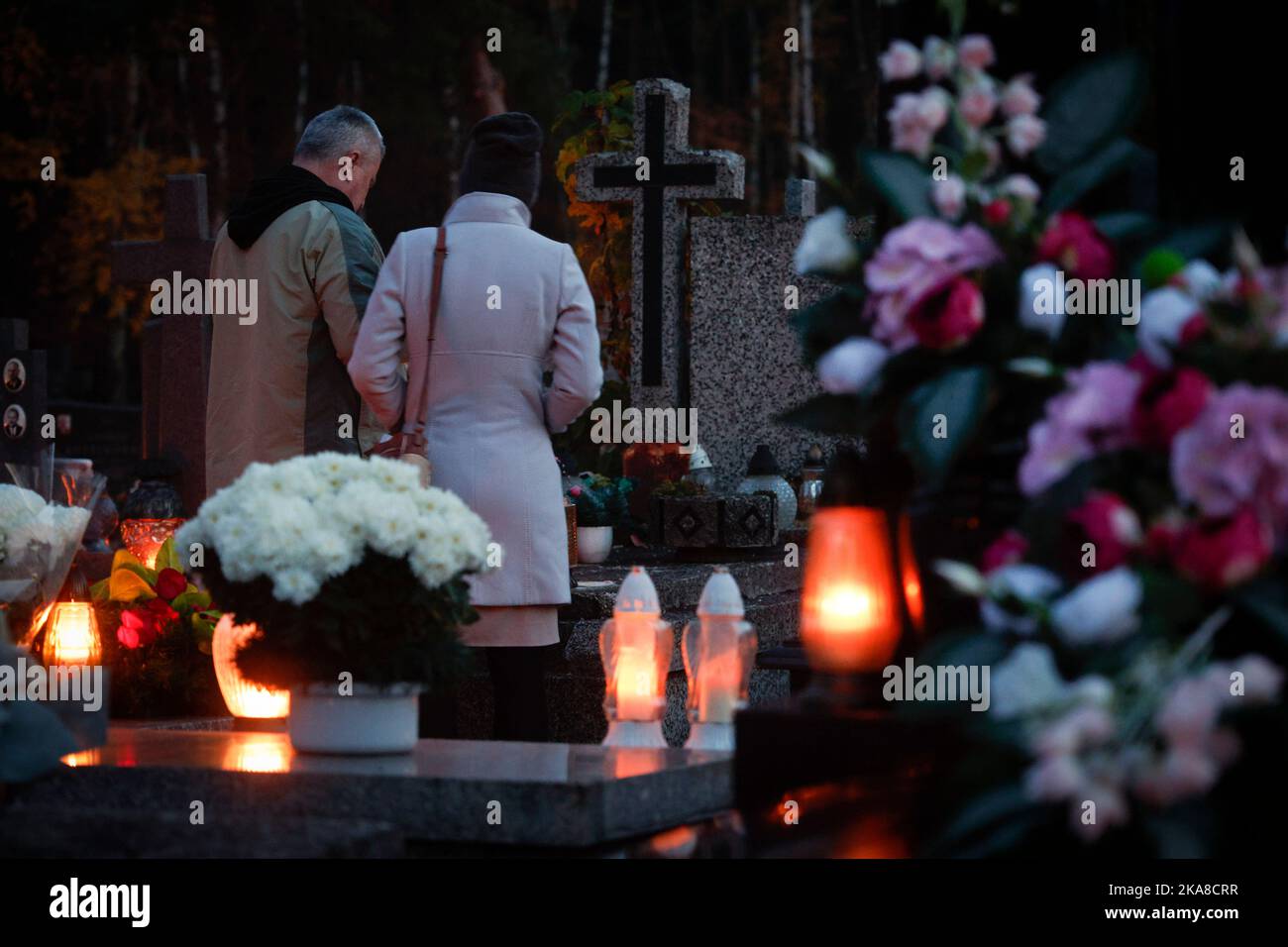 People are seen visiting graves to prepare for All Saints Day at a ...