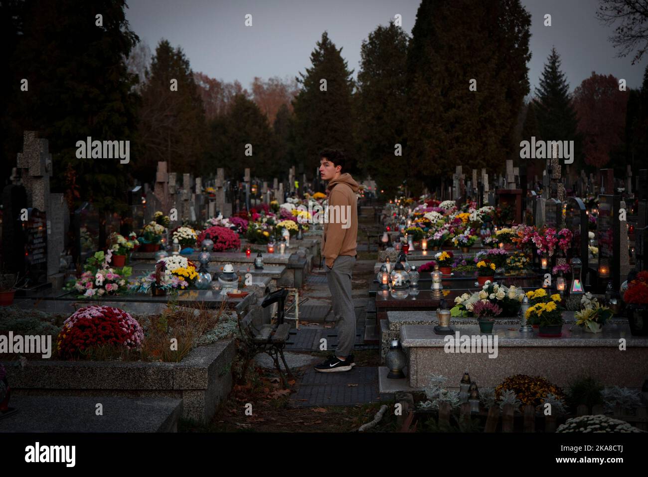 People are seen visiting graves to prepare for All Saints Day at a ...