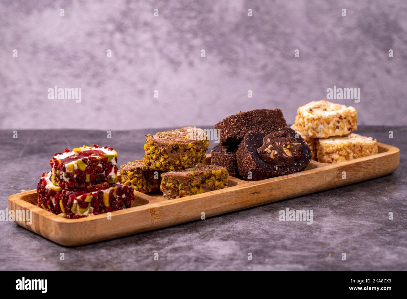 Mixed Turkish delight varieties on a dark background. Pistachio ...
