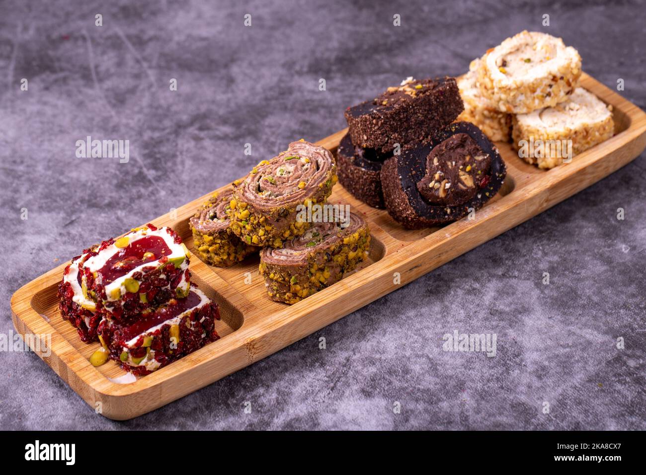 Mixed Turkish delight varieties on a dark background. Pistachio ...