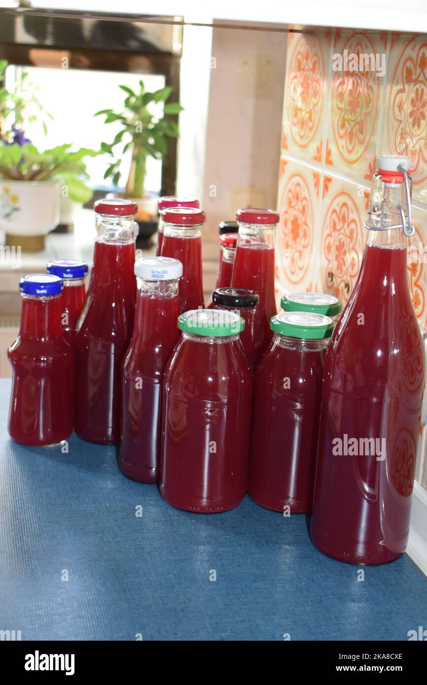 homemade red grape juice in reused bottles Stock Photo - Alamy