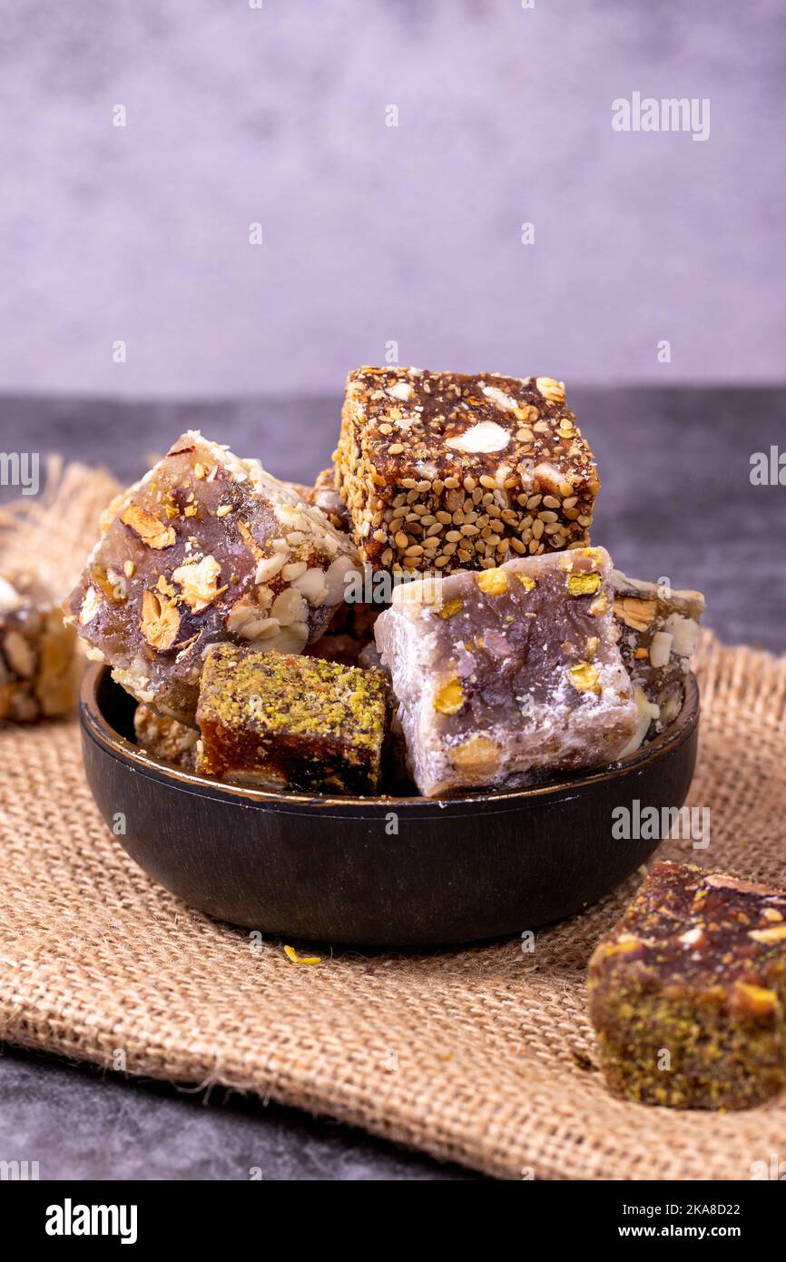 Mixed Turkish delight varieties on a dark background. Pistachio ...
