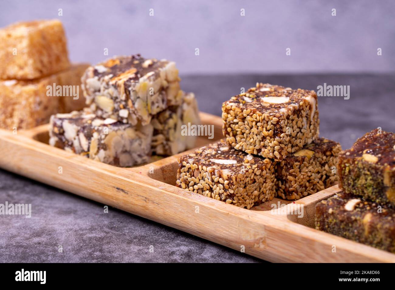 Mixed Turkish delight varieties on a dark background. Pistachio ...