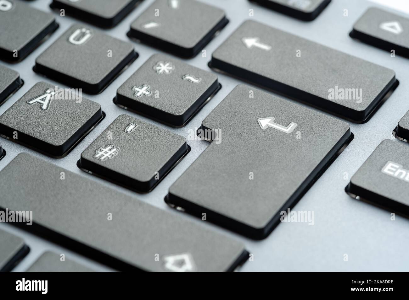 Enter key on a simple generic grey office desktop PC keyboard, object ...