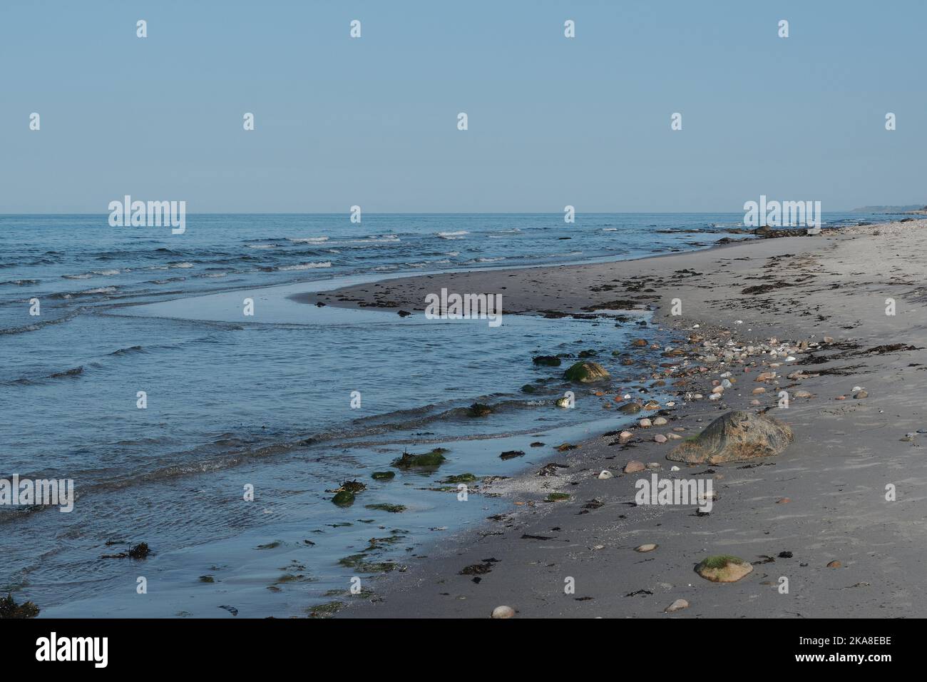 A beautiful view of the ocean waves hitting the mossy rocks at the ...