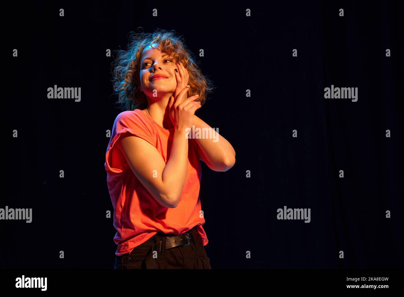 Young expressive emotional girl with short curly red hair posing ...